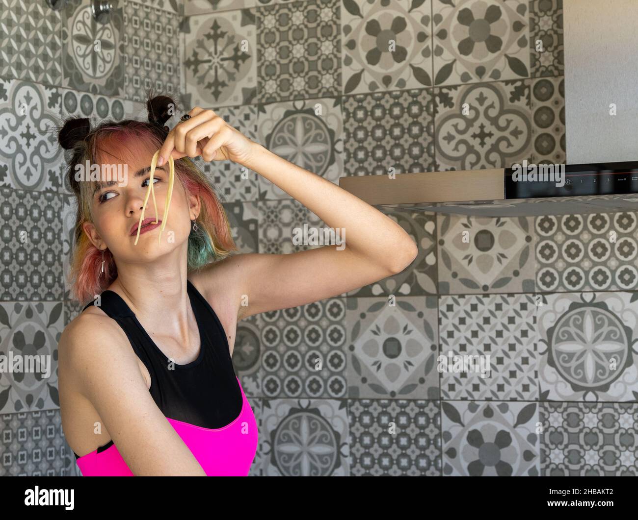 distracted woman looking to the side while eating spaghetti with her ...