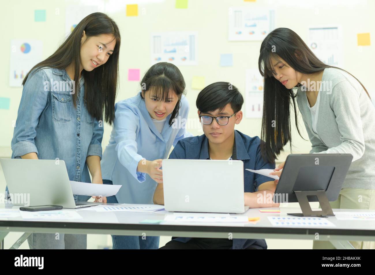 Group of people working together using laptop, group of students using ...