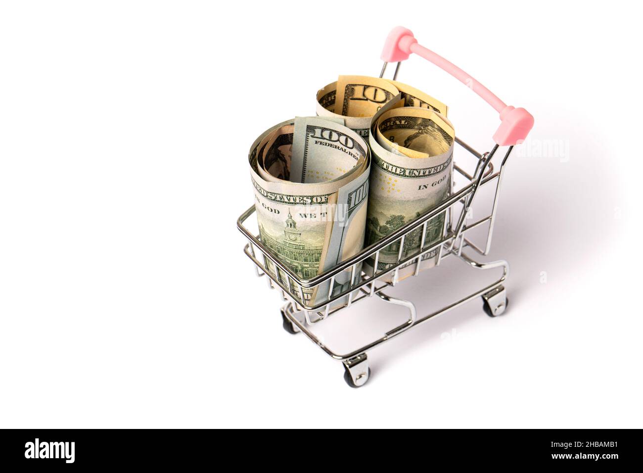 The shopping cart with pink handle filled with one hundred dollar bill ...