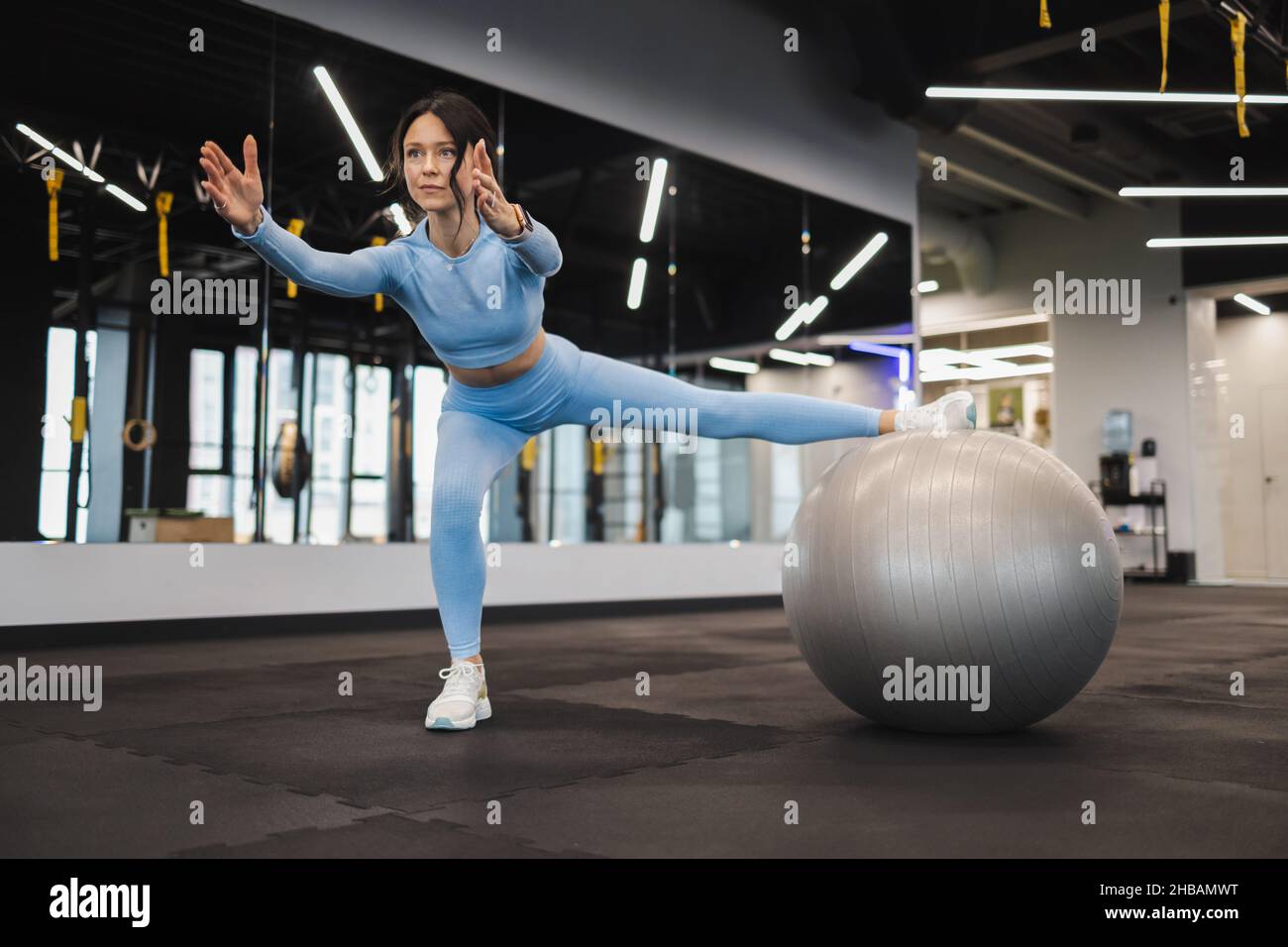 Pretty woman working out with a fitness ball in the gym Stock Photo - Alamy