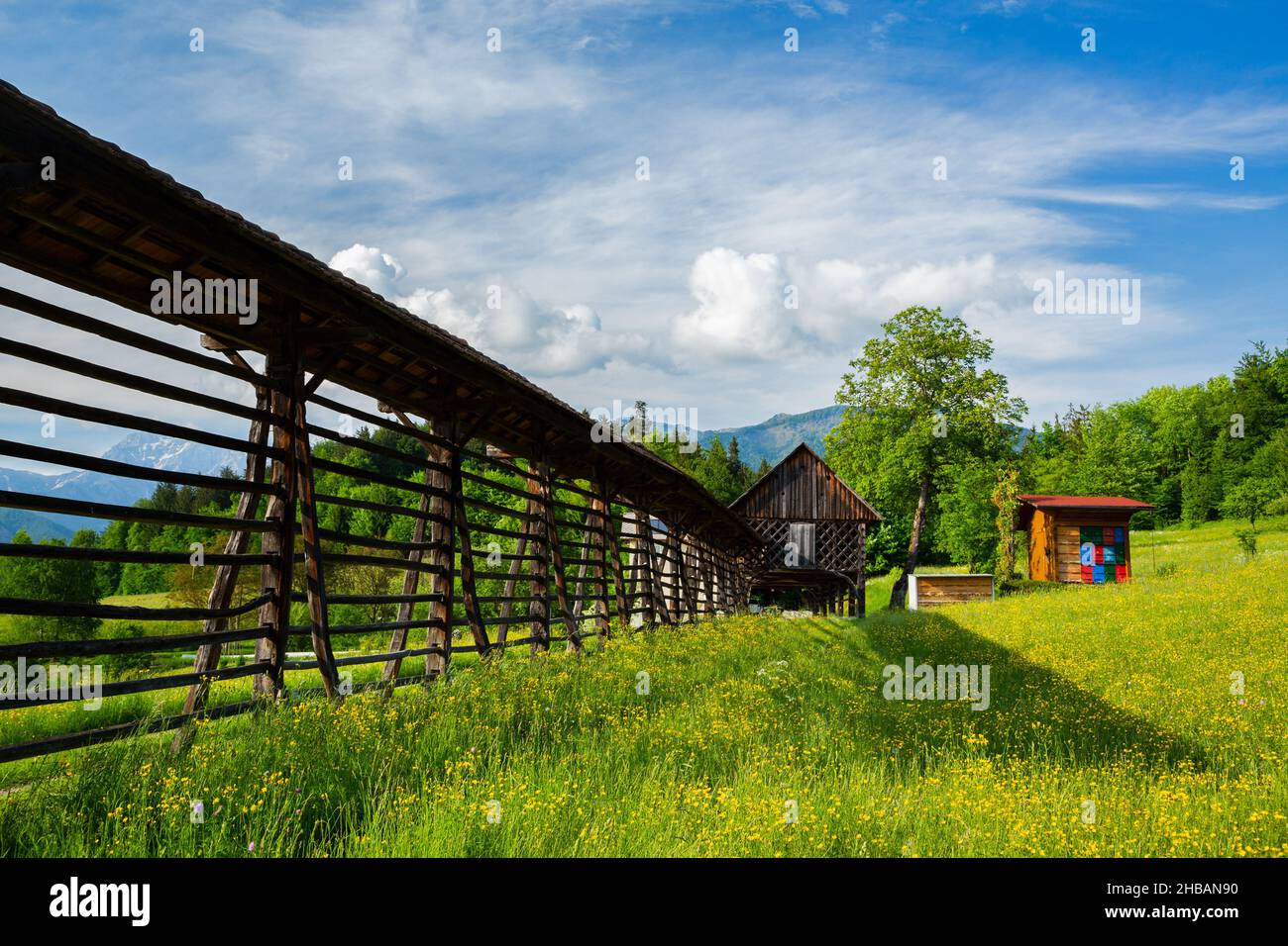 Icons of Slovenia; Kozolec (hay drying rack) and beehive. Photographed ...