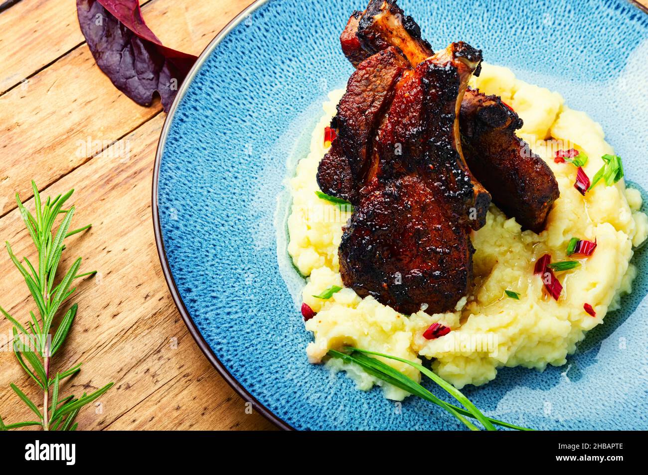 Tasty meat steak on the bone and mashed potatoes Stock Photo - Alamy