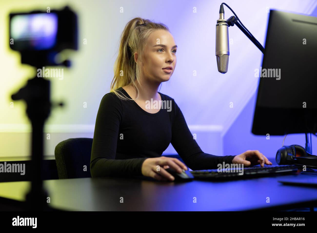 Professional e-sport gamer girl streaming and plays online video game ...