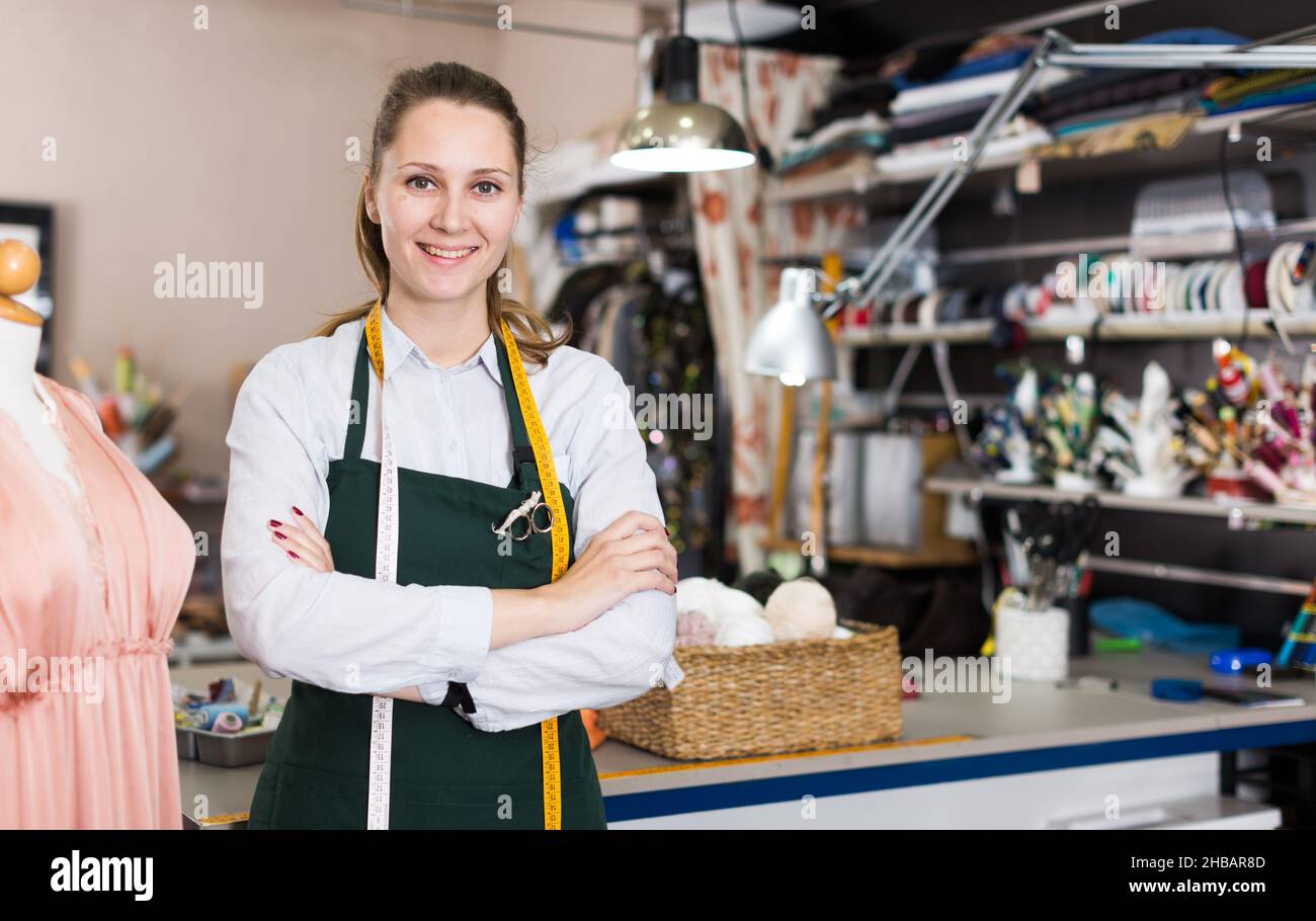 Portrait of woman designer who is standing on her workplace in time ...