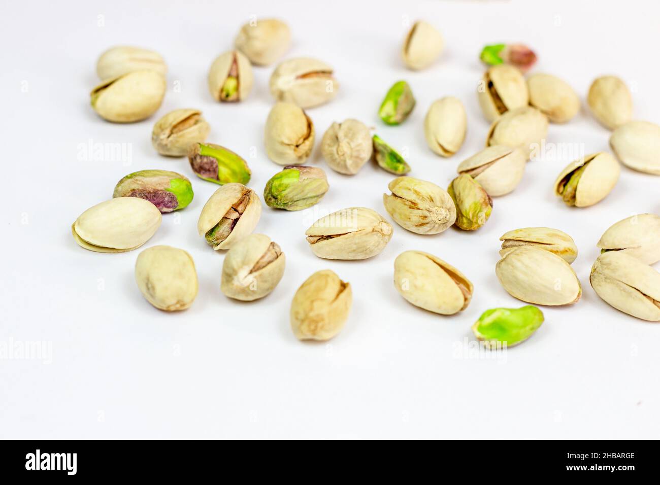 Roasted salted pistachio nuts in nutshell on light background Stock Photo - Alamy