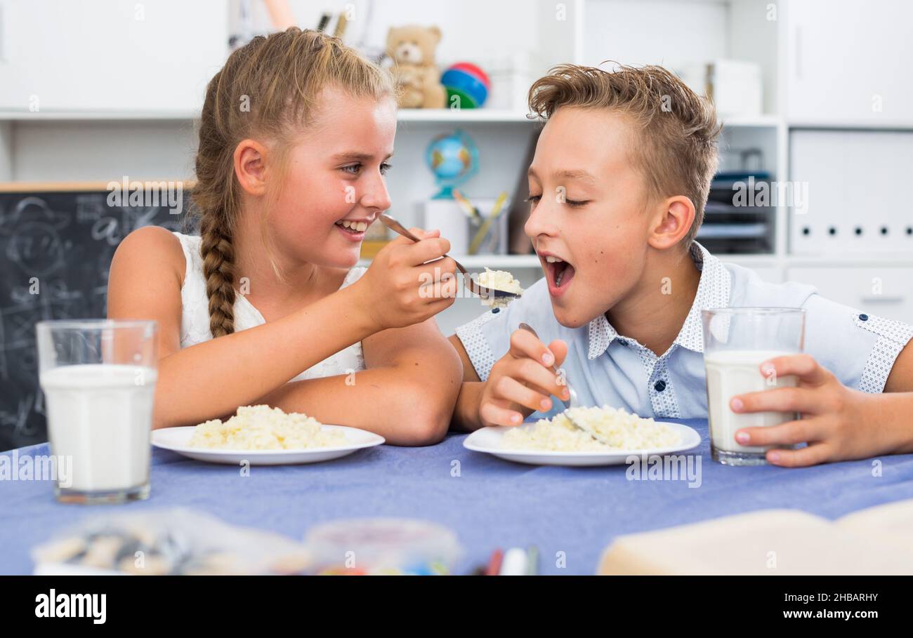 Friends are feed each other during dinner Stock Photo - Alamy