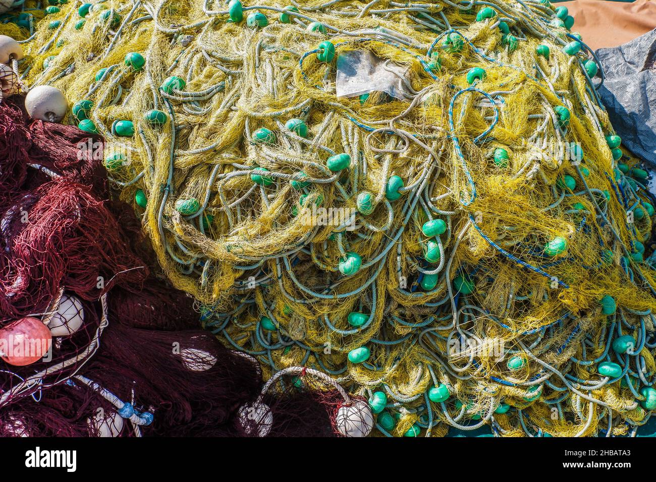 Top view of old colorful fishing nets with ropes under the sunlight ...