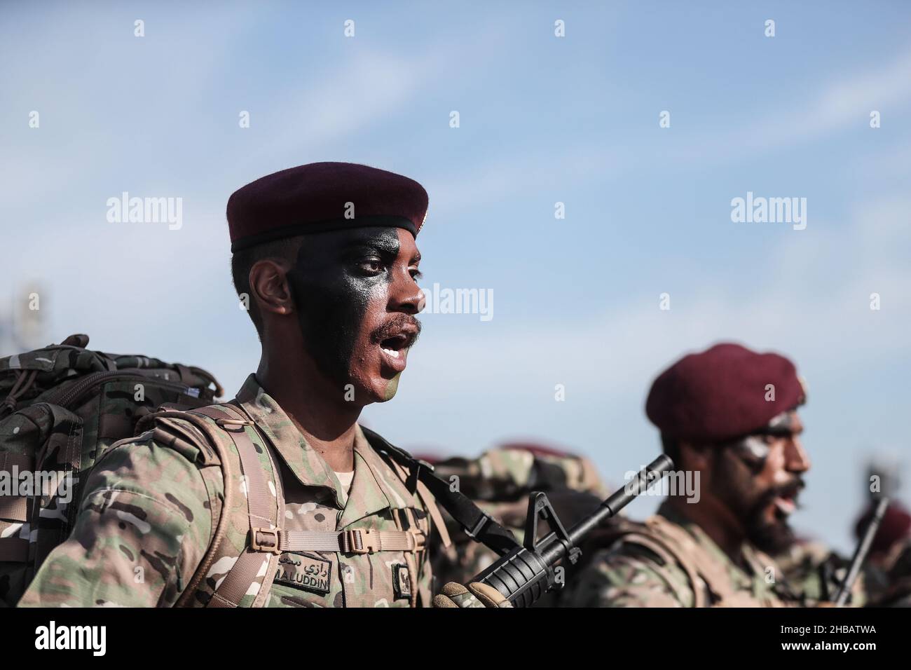 Doha, Qatar. 18th Dec, 2021. Armed soldiers in uniform march on a ...