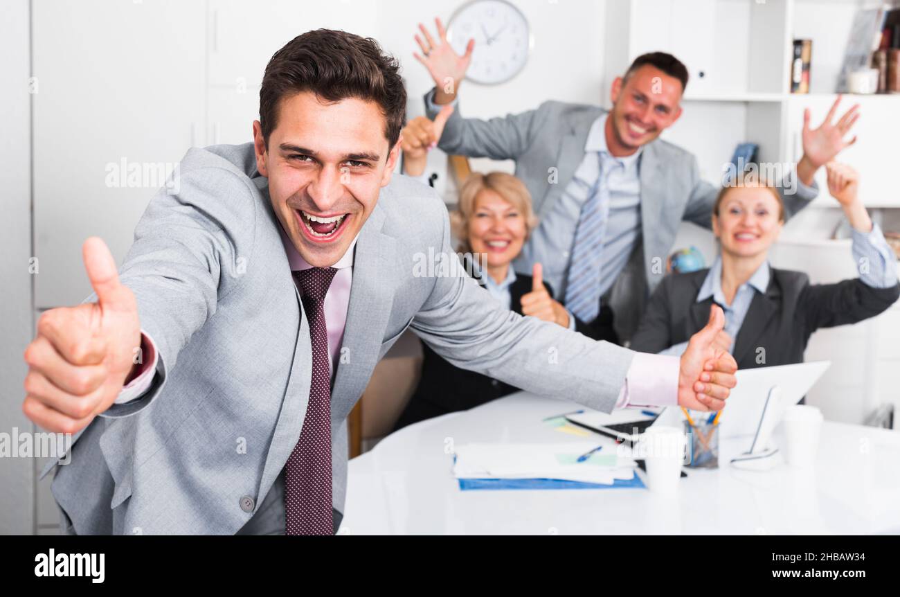 Happy business group with smiling man at office Stock Photo - Alamy