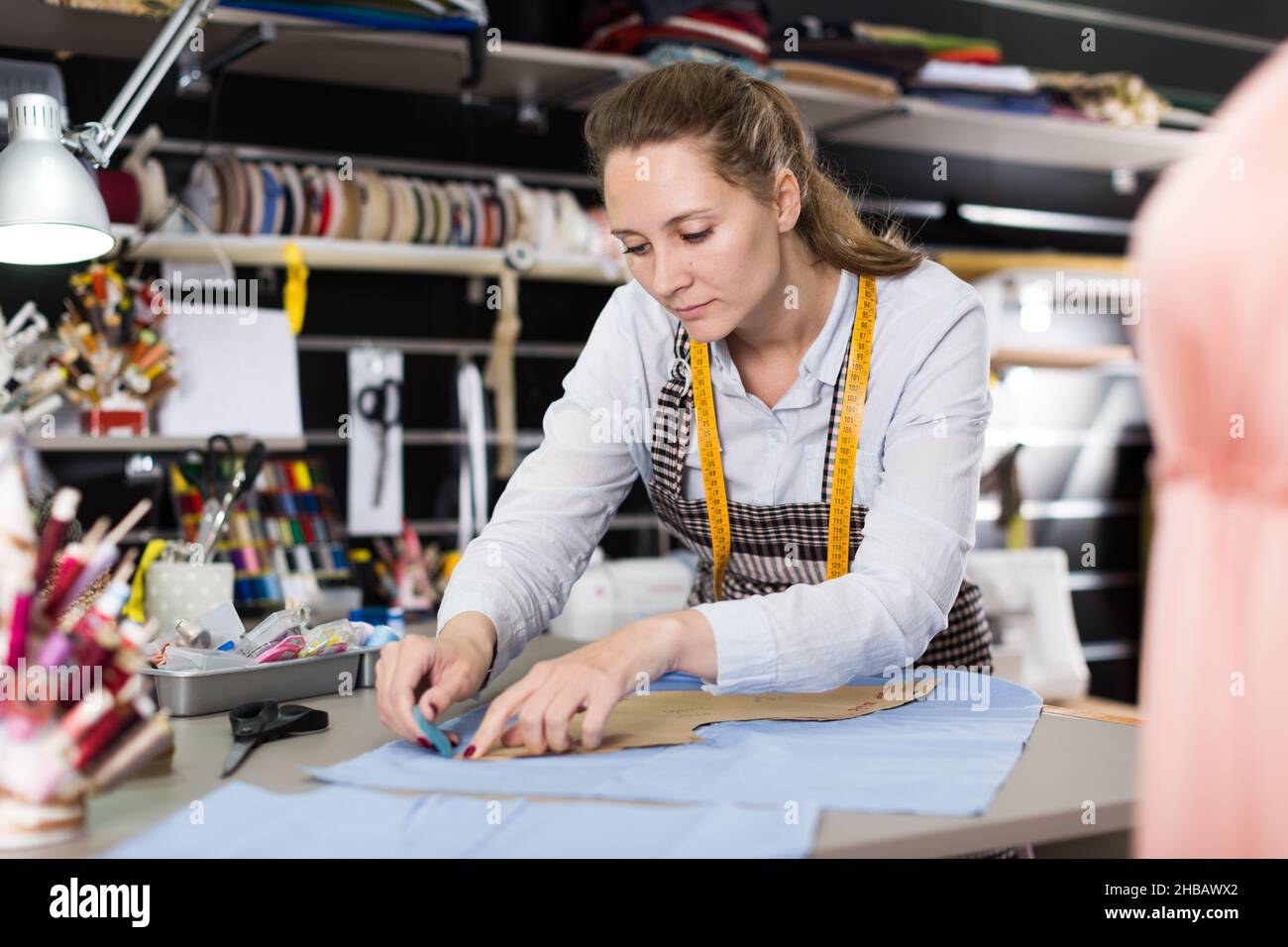 Portrait of woman designer who is doing new pattern for dress Stock ...