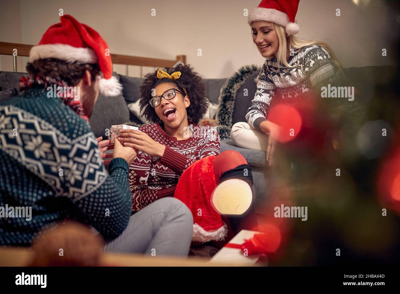 Group of festive friends celebrating the Christmas together indoors ...