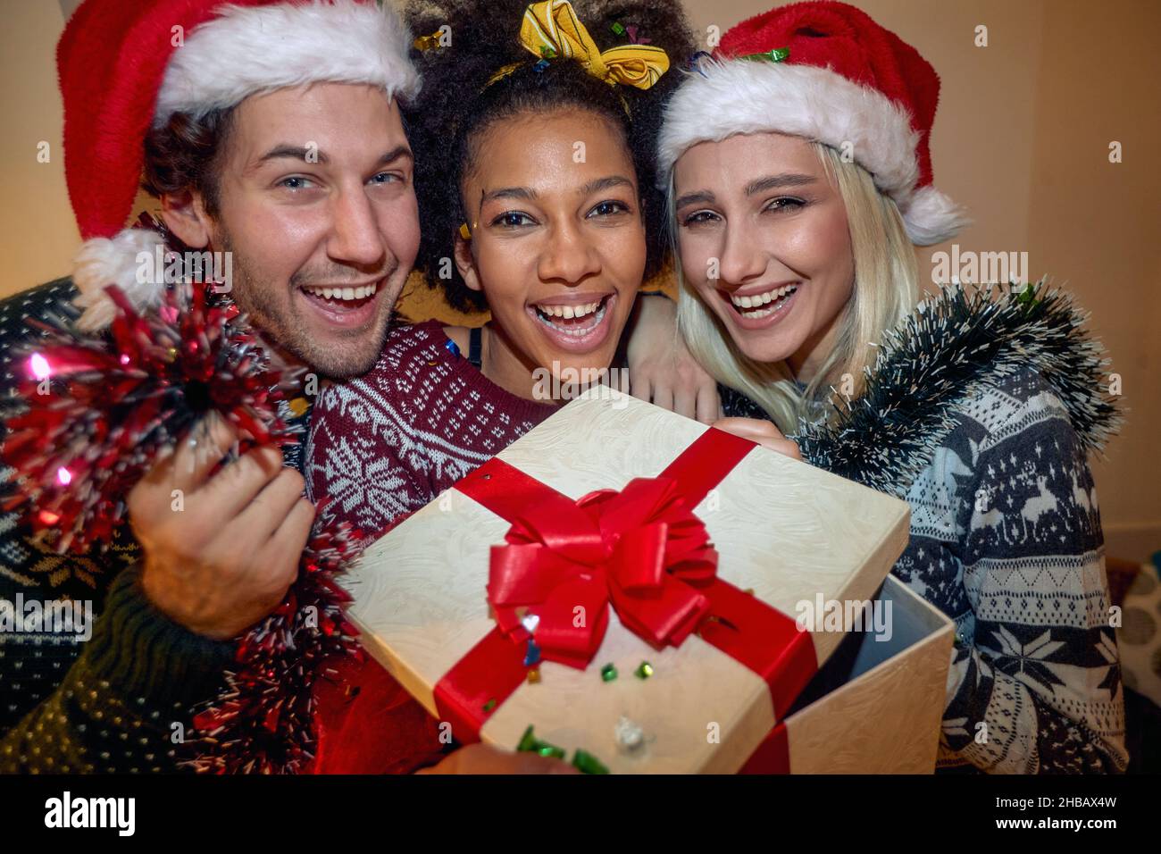 Multiethnic group of joyful friends celebrating the New Year together ...