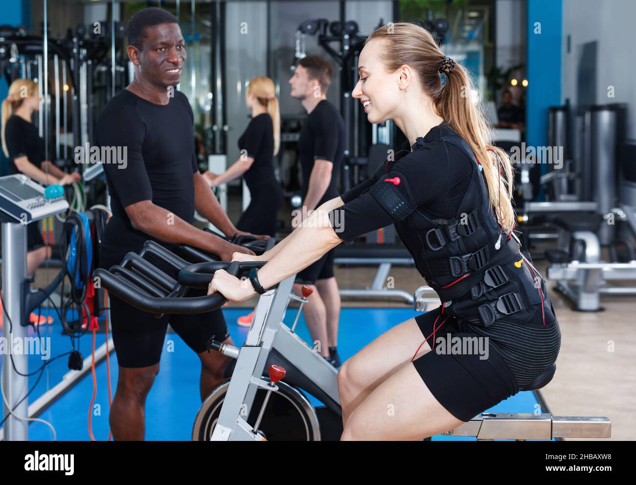 Athletic young girl during electric muscle stimulation workout in ...