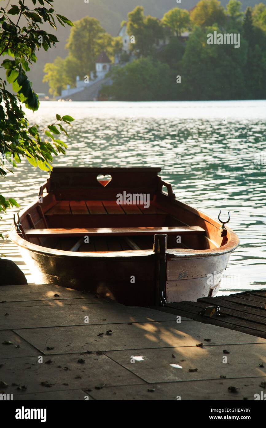Rowing boat moored in the late summer afternoon on Lake Bled with the ...