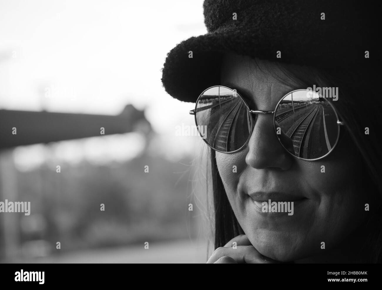 Grayscale portrait of a Caucasian pretty young lady with sunglasses ...