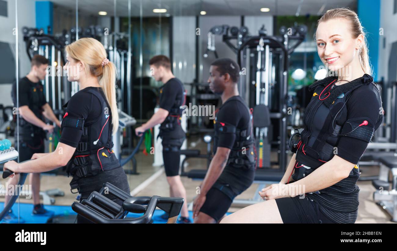 Athletic young girl during electric muscle stimulation workout in ...