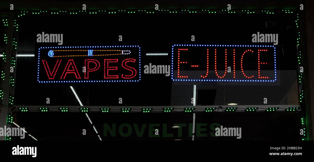 Vapes, e-Juice and Novelties Sign in Window of local smoke shop Close ...