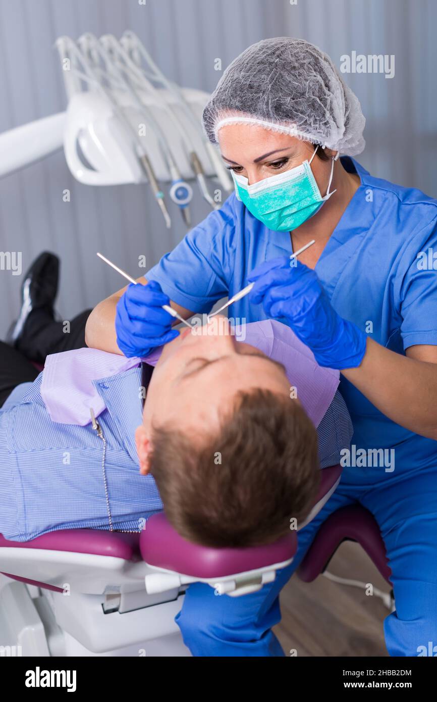adult dentist checking teeth of patient Stock Photo - Alamy