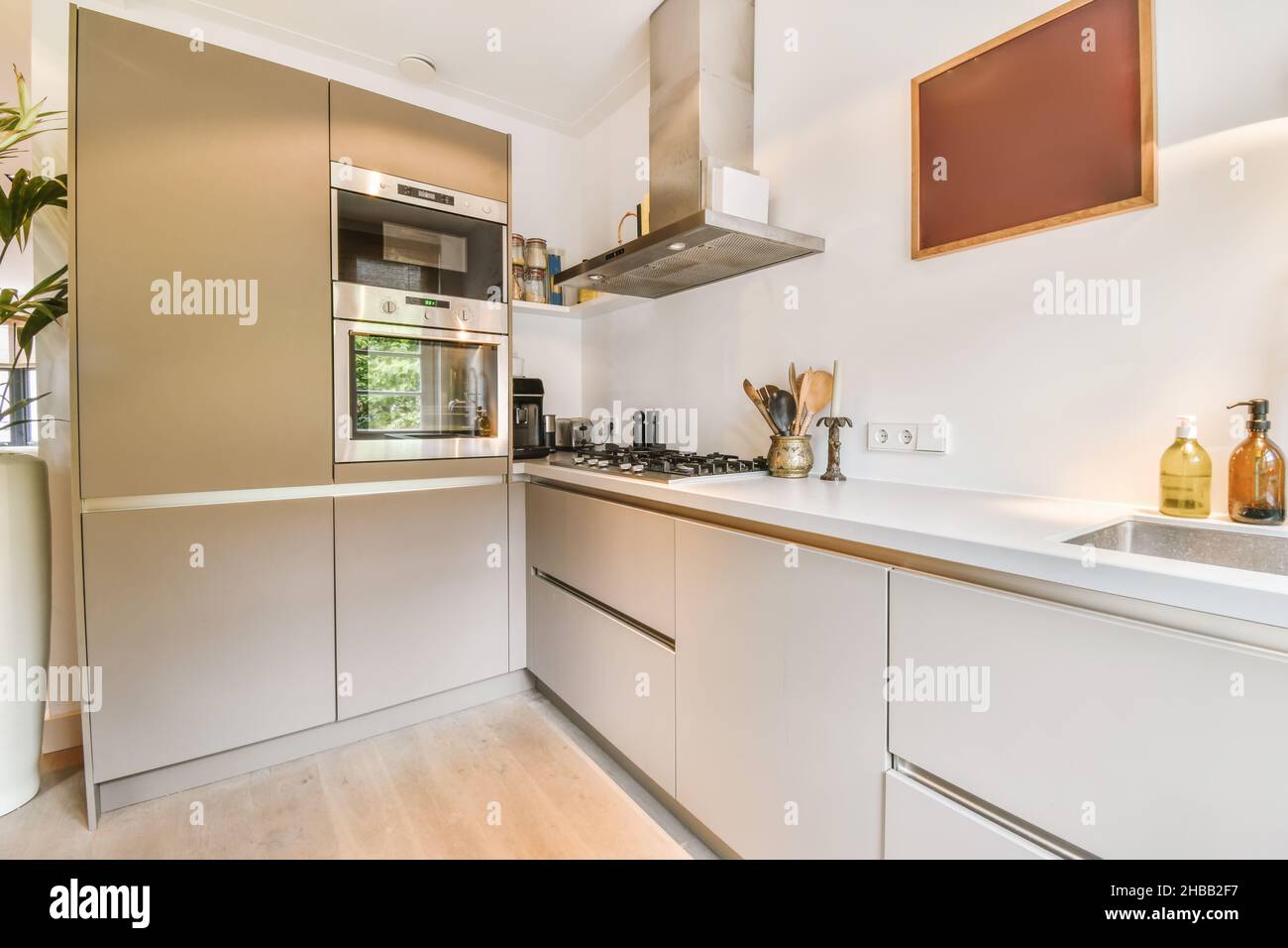 Small kitchen area with gray kitchen unit Stock Photo - Alamy
