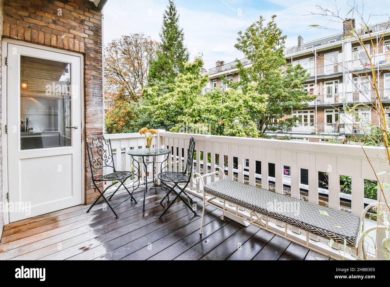 Sleek balcony design with metal table and chair Stock Photo - Alamy