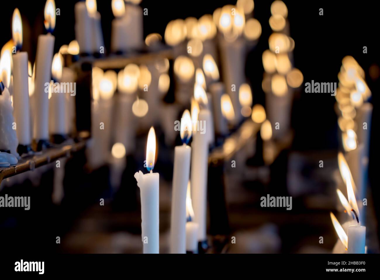 Religion background with burning white candles on fireplace at Church ...