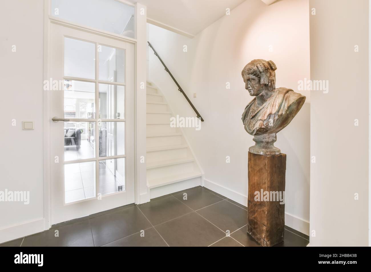 Amazing design of a corridor with a statue in a chic home Stock Photo ...