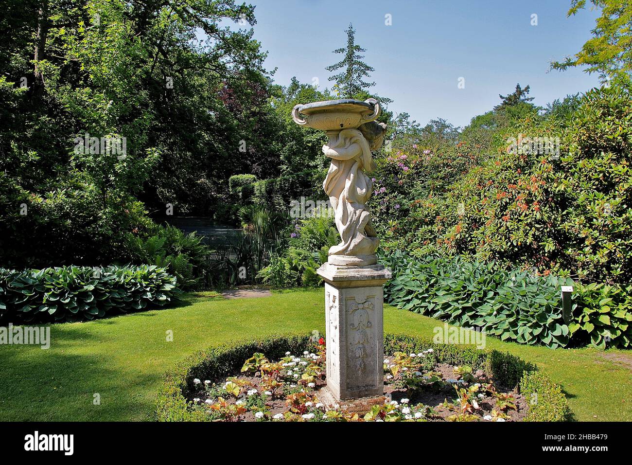 Small marble statue placed in a small square on a huge park gull of big ...