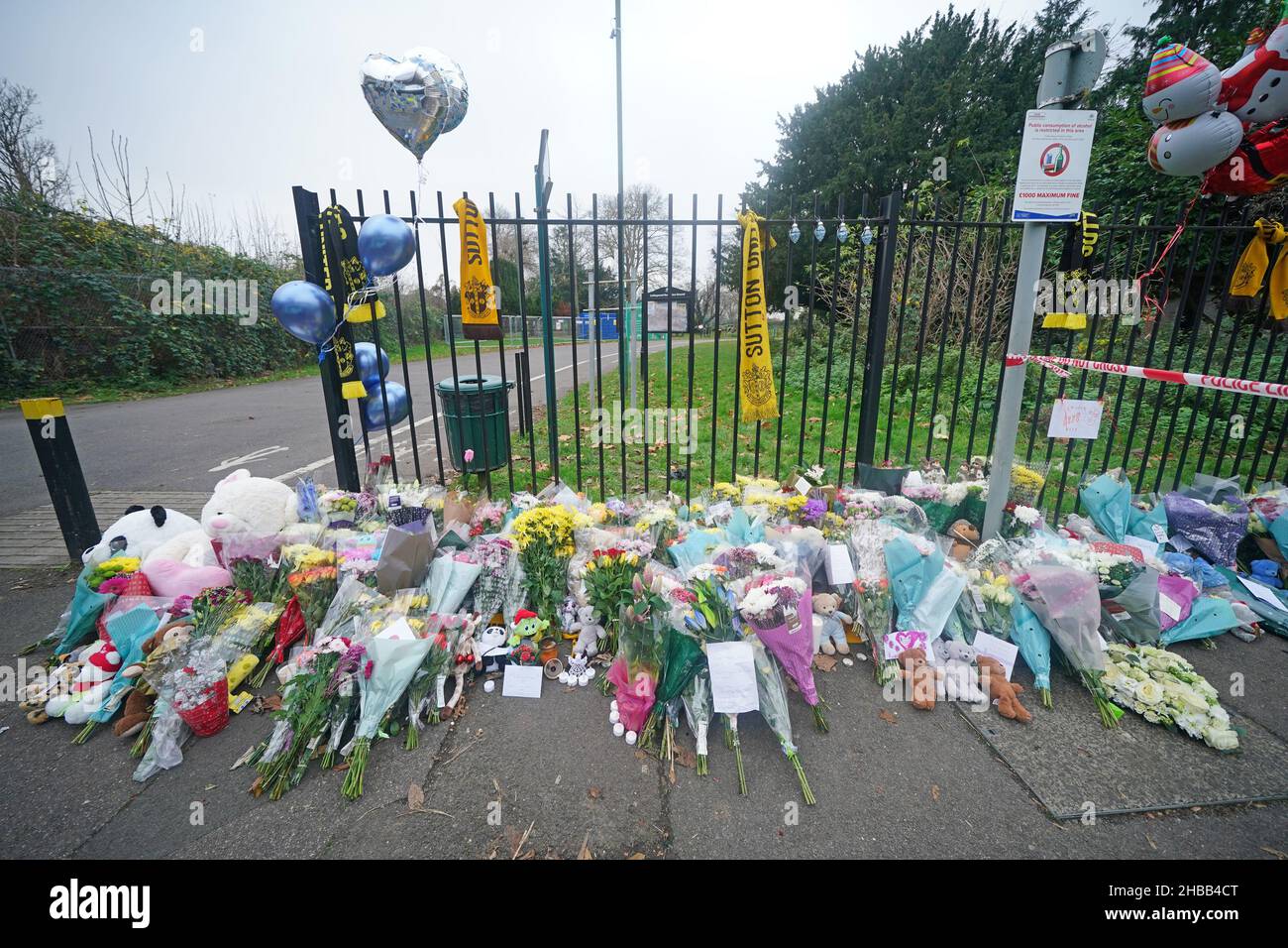 Flowers and toys are left near the scene in Sutton, south London, where ...