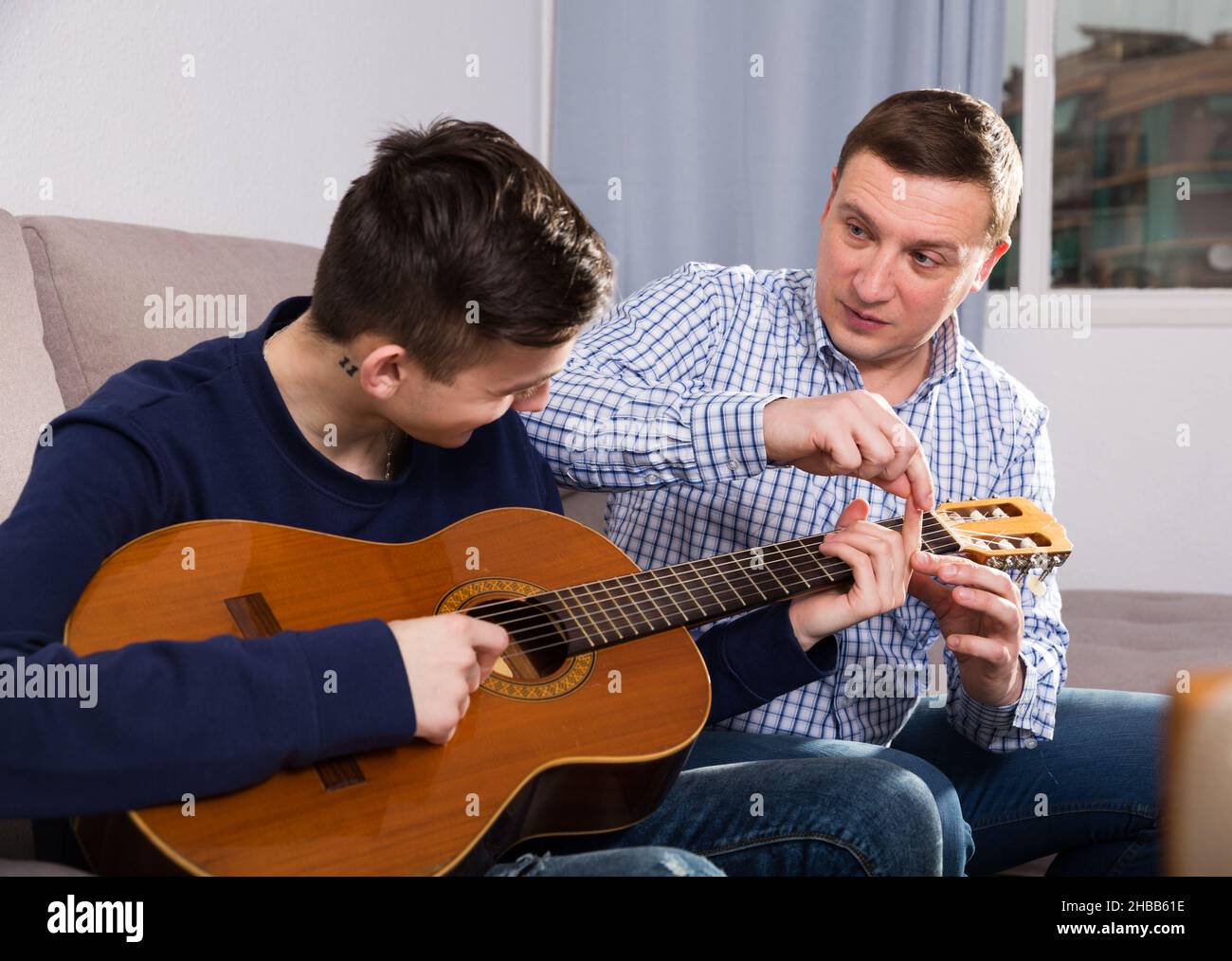 Man playing guitar inside room hi-res stock photography and images - Alamy