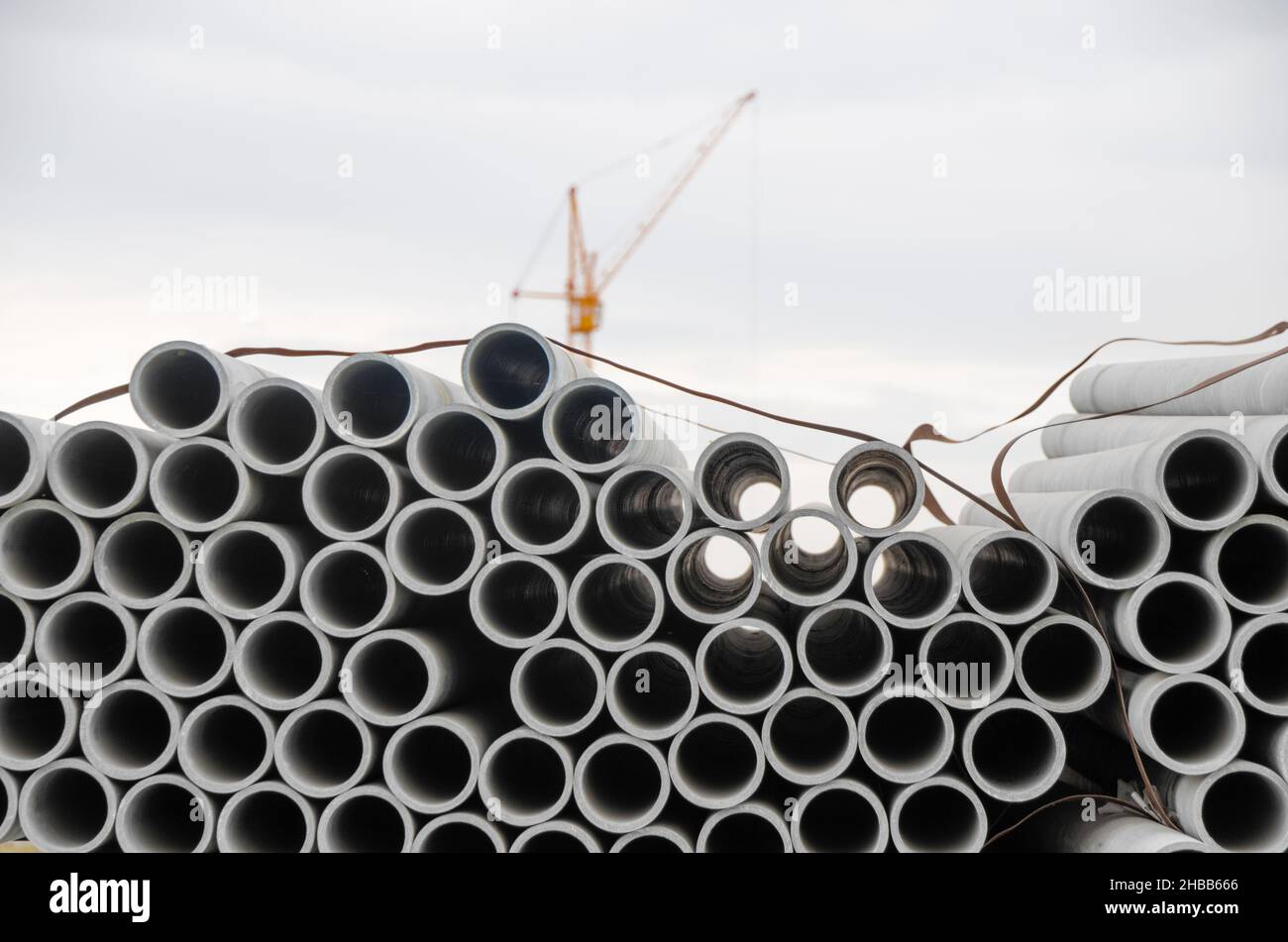 Asbestos pipes and yellow crane Stock Photo - Alamy