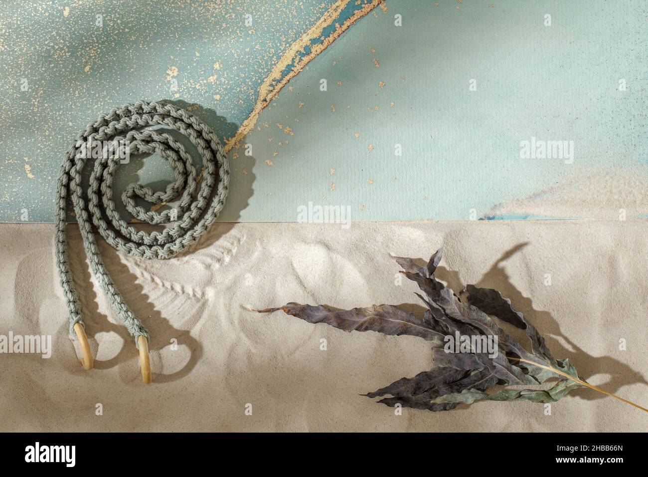 Unrolled ocean blue yoga mat, woven rope for stretching and dried ...