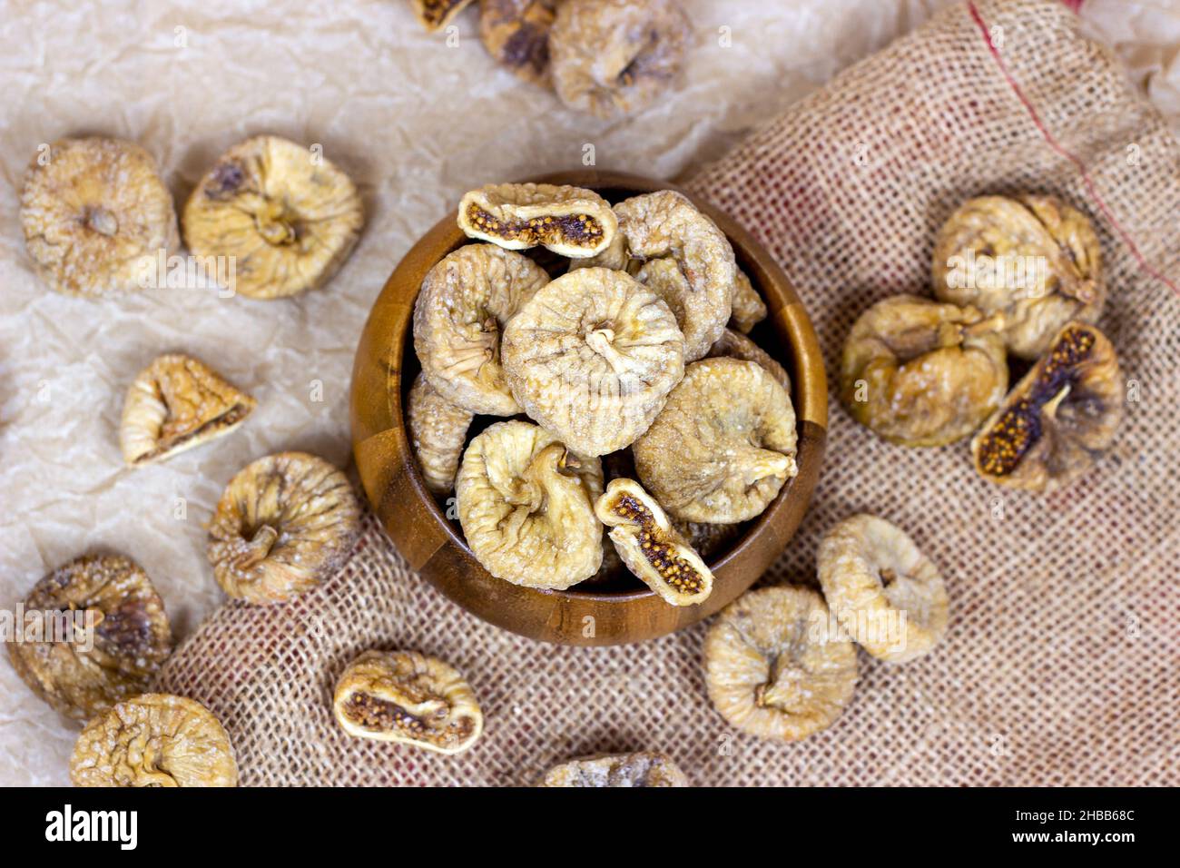 Top view of sweet dried italian figs in the wooden bowl on the brown ...