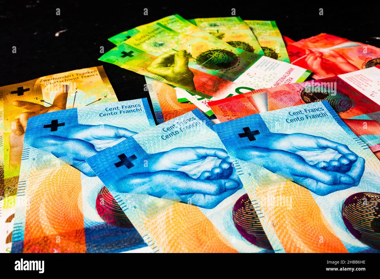 Stack of Swiss franc banknotes isolated on a dark background Stock ...
