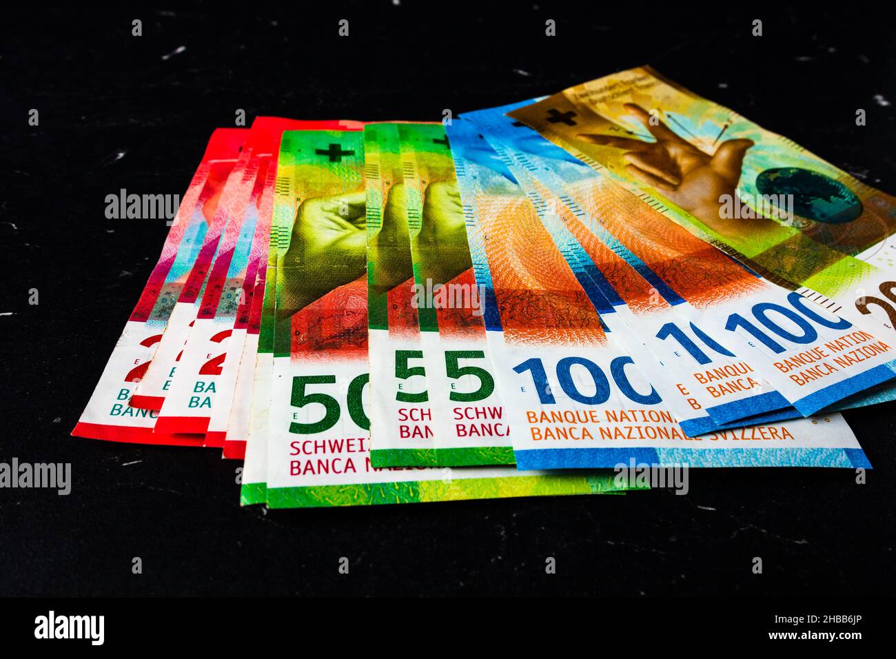 Stack of Swiss franc banknotes isolated on a dark background Stock ...