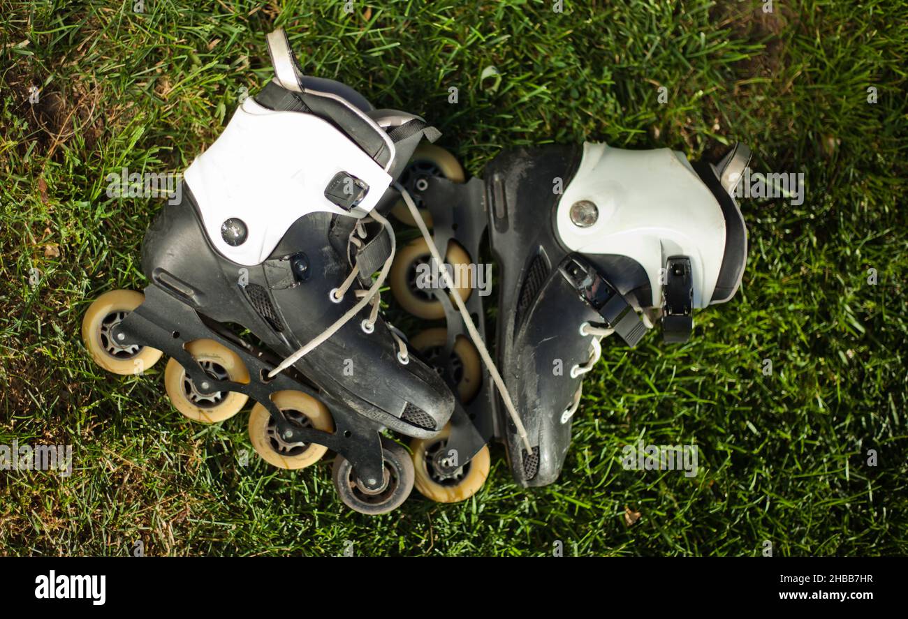 Old roller skates on the lawn grass. Top view. Sport concept Stock ...