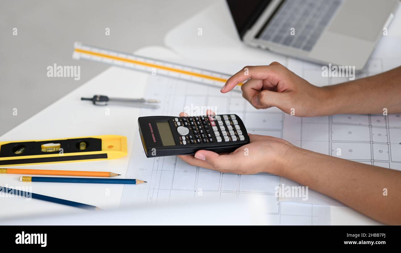 Hand using on calculator, engineers use a calculator to calculate house ...