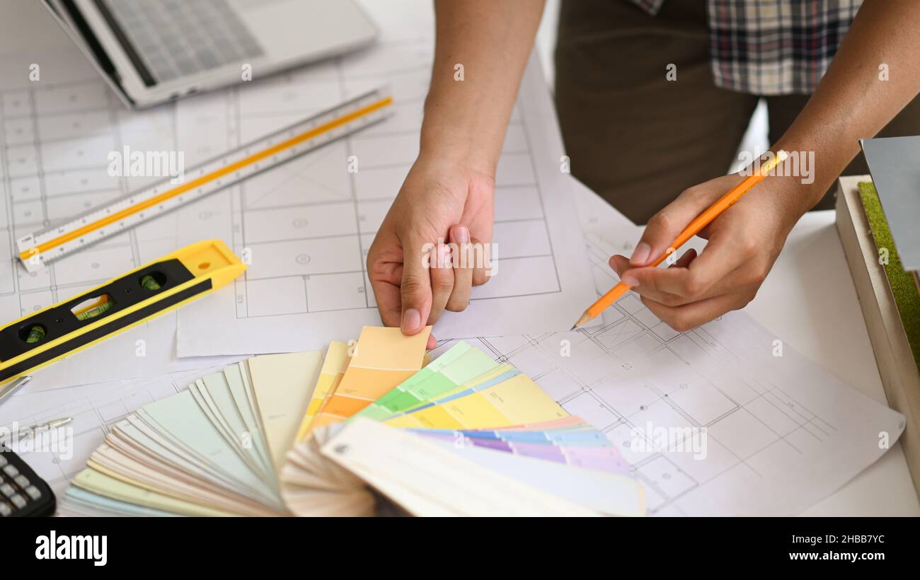 A young man holding a color chart, a young architect chooses a color ...