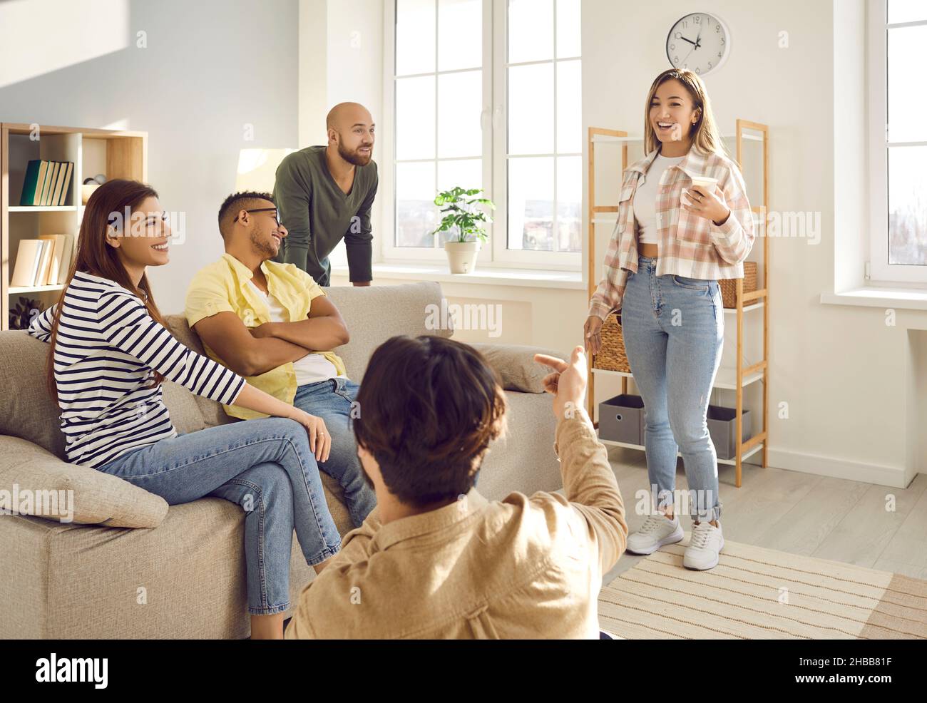 Diverse group of happy young people having fun during a friendly ...