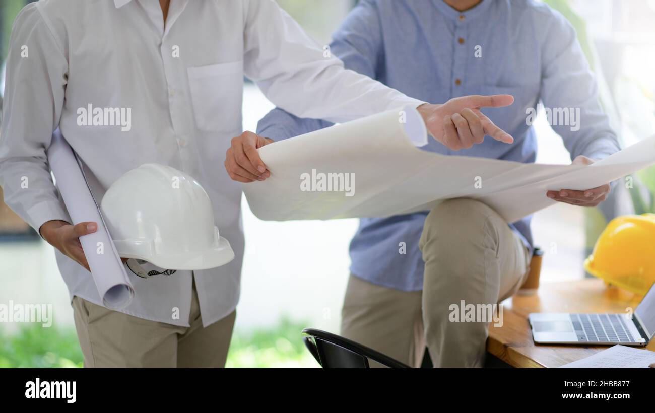 Designers and builders view house plans to plan for construction work ...