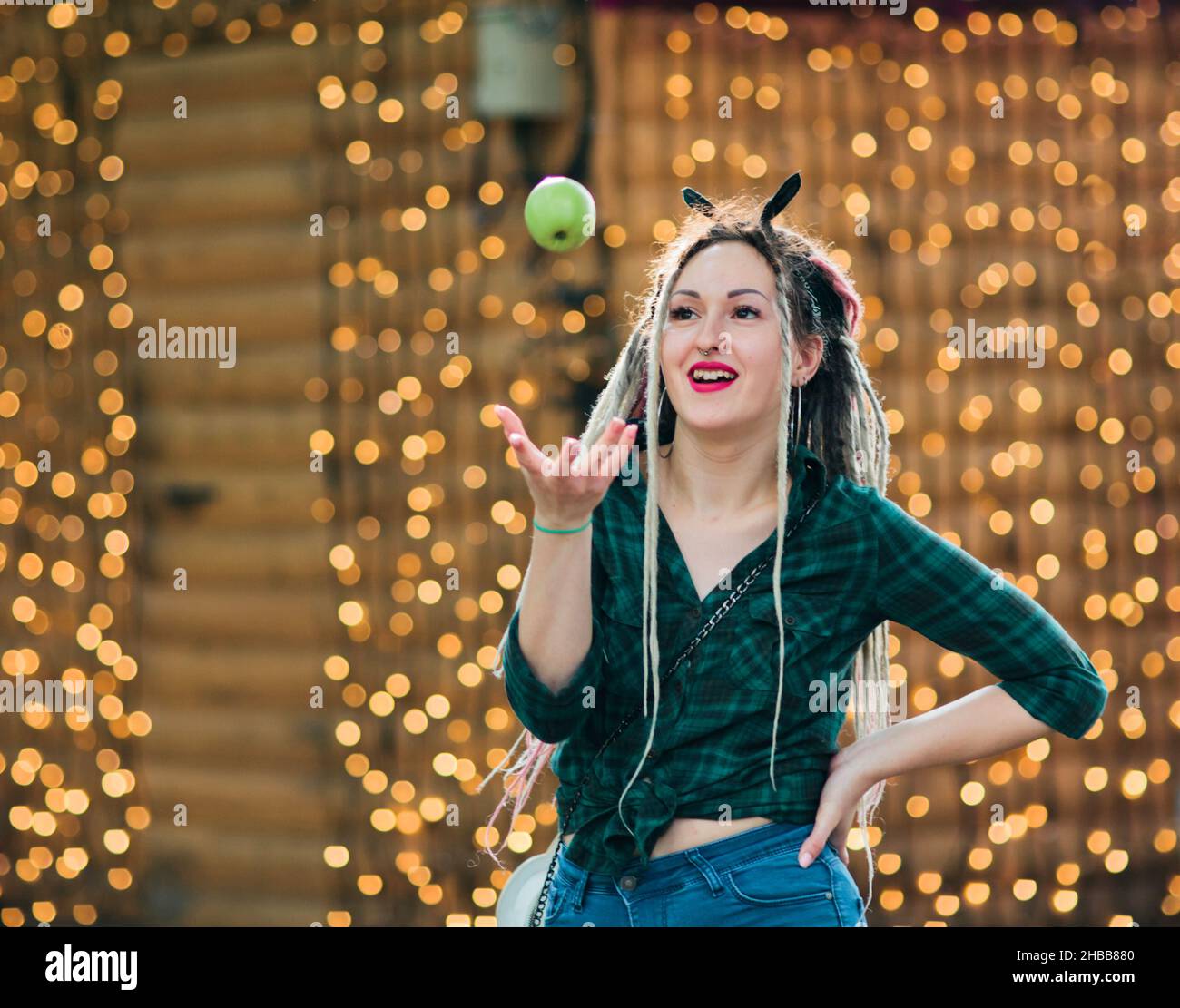 Inordinate young woman with dreadlocks hairstyle and fashionable summer ...