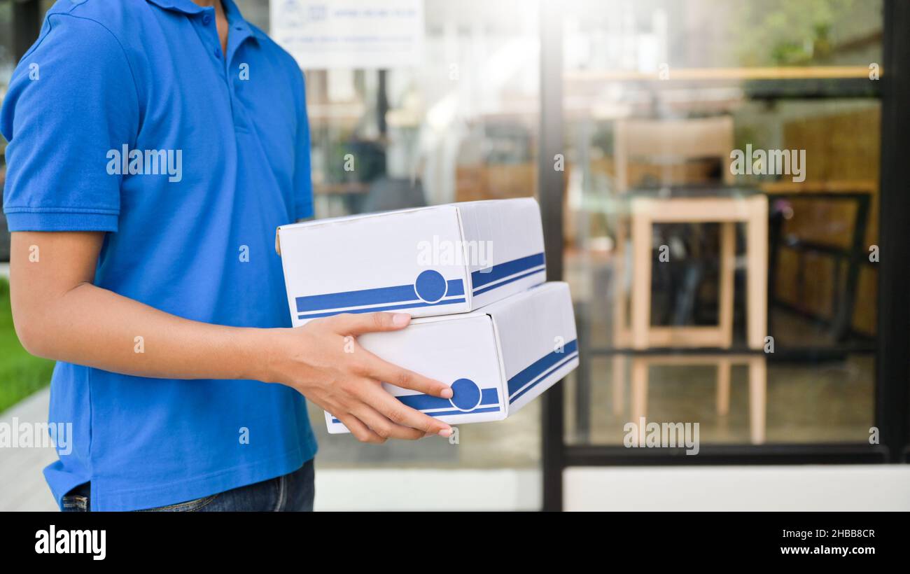 The officer delivers the parcel to the customer home Stock Photo - Alamy