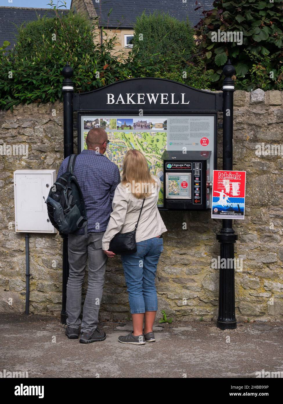 Couple looking at Tourist Map and Information Sign, Bakewell ...