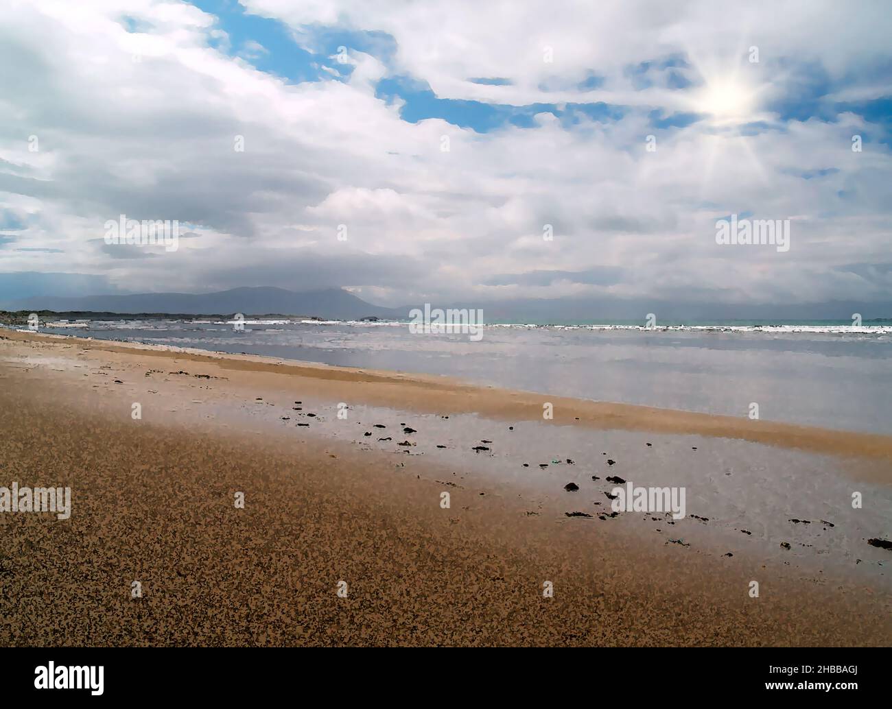 The deserted beach known as Inch Strand and the Atlantic ocean breaking ...