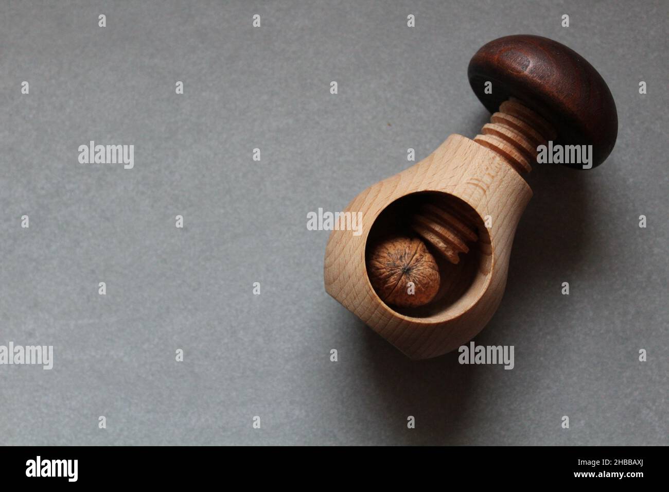 Wooden nutcracker with a whole walnut in it Stock Photo - Alamy