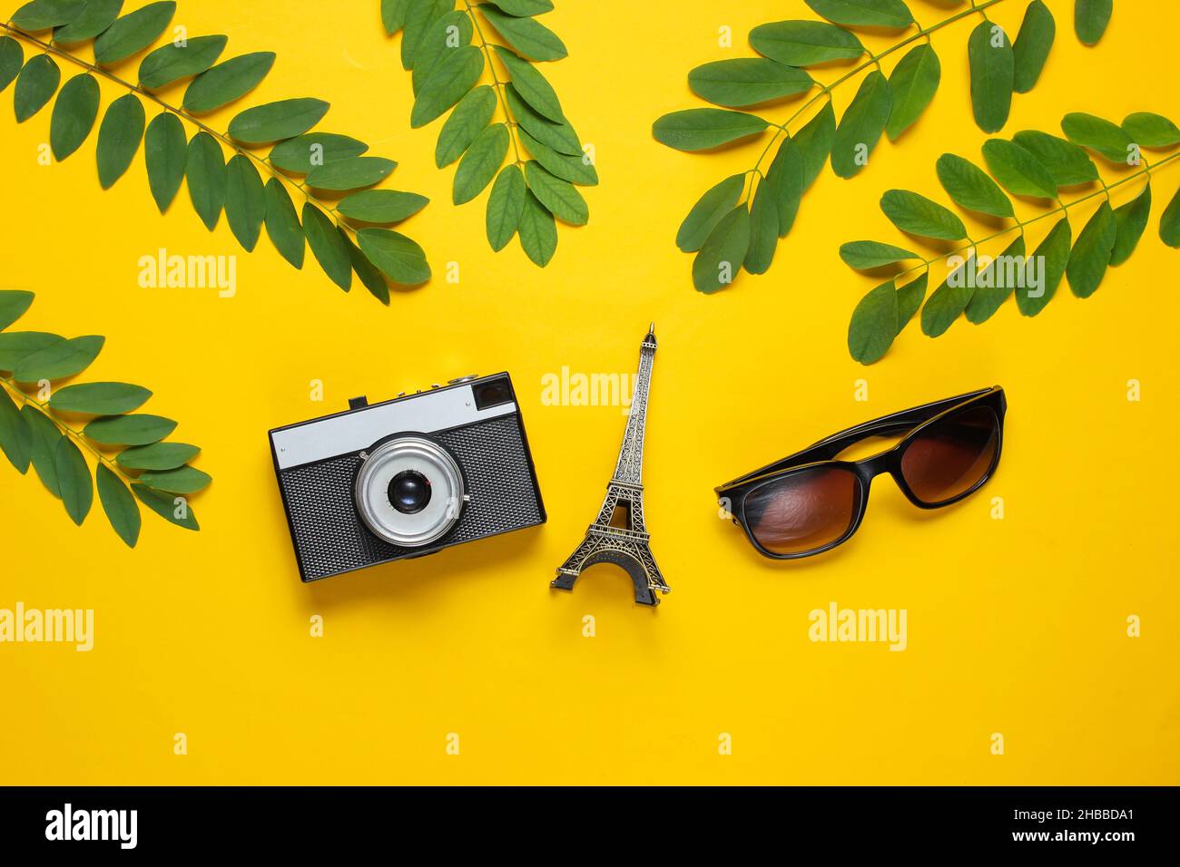 Jorney to Paris. Sunglasses, retro camera, figurine of the Eiffel tower ...