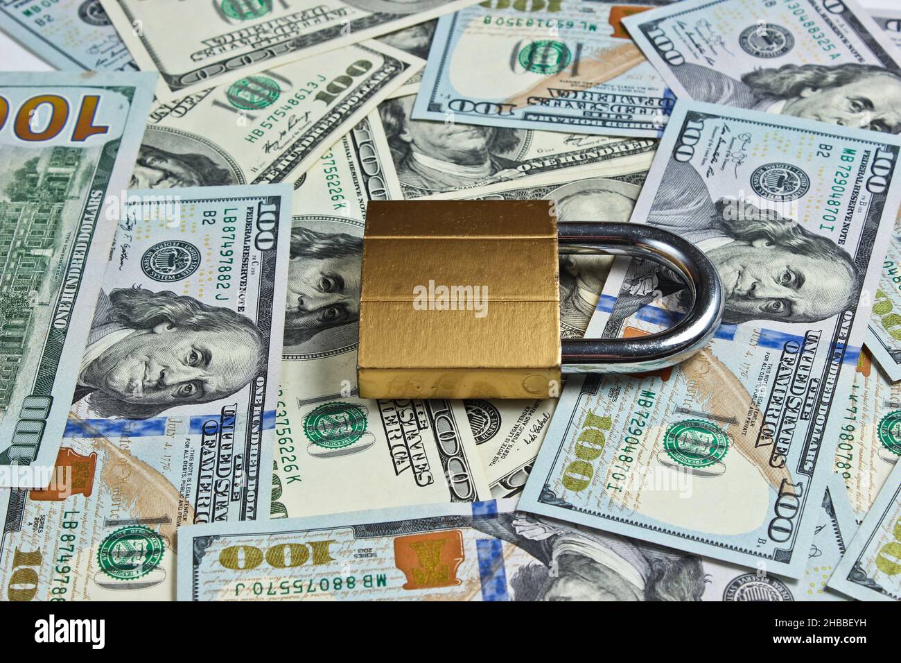 Golden lock with key on background of dollar bills Stock Photo - Alamy