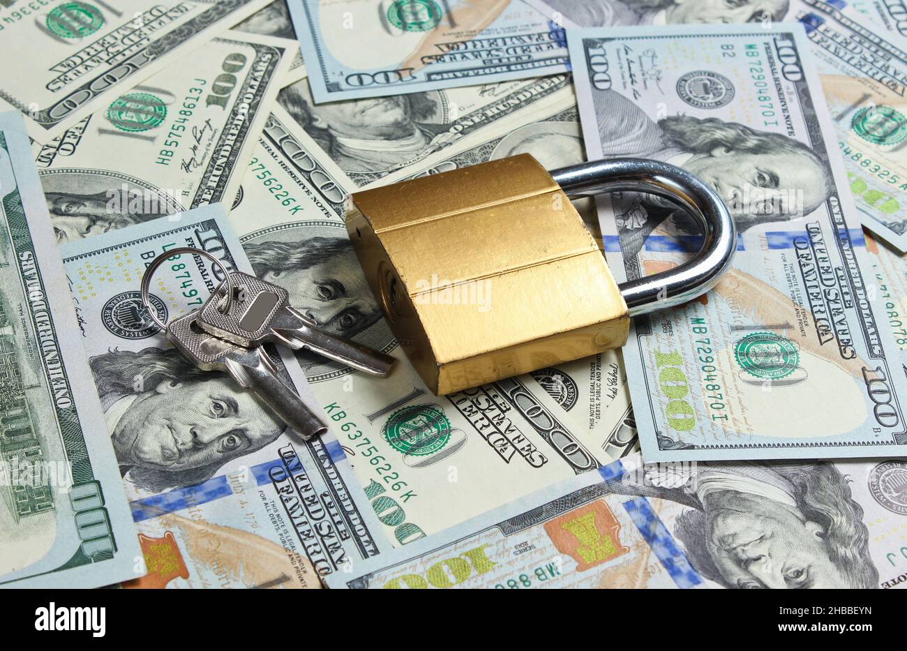 Golden lock with key on background of dollar bills Stock Photo - Alamy
