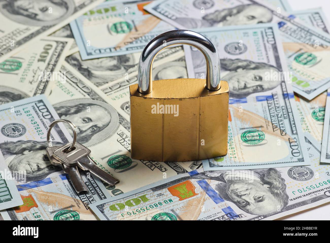 Golden lock with key on background of dollar bills Stock Photo - Alamy