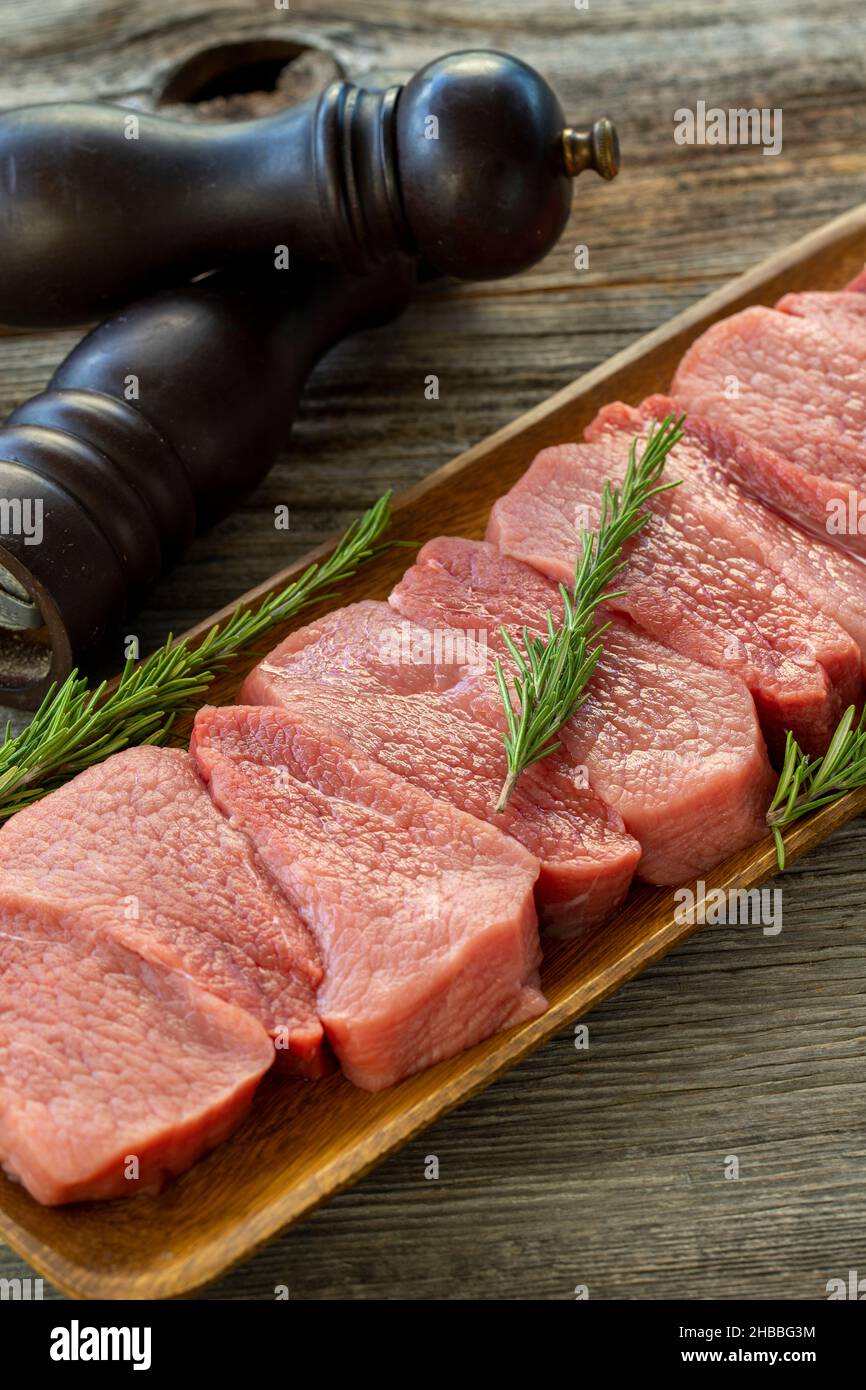 Raw roast beef on wooden background. Close-up roast beef. Vertical view ...