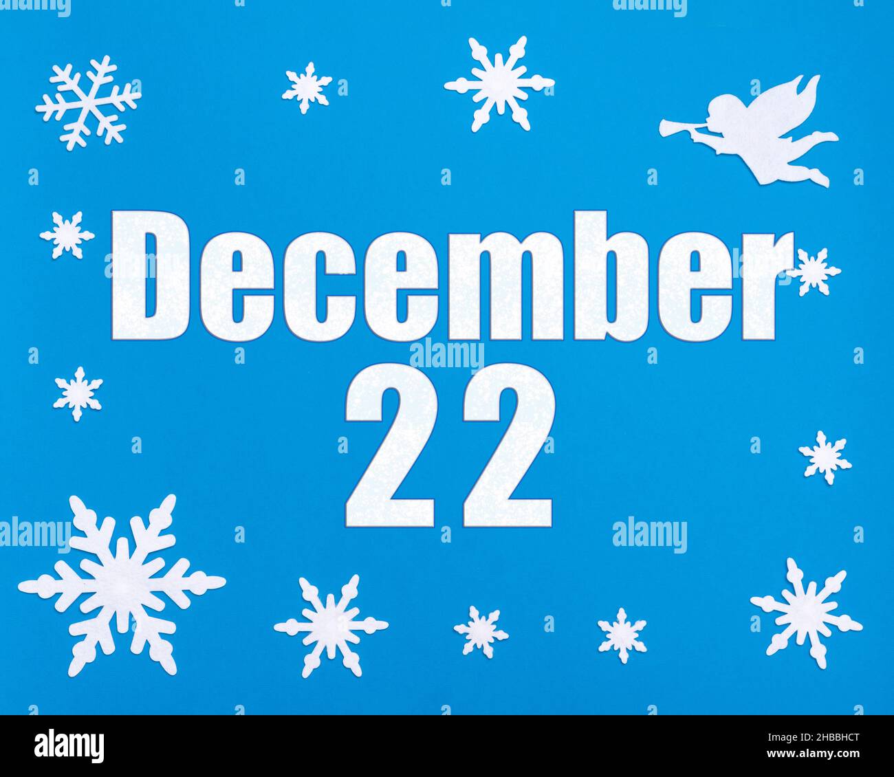December 22nd. Winter blue background with snowflakes, angel and a ...